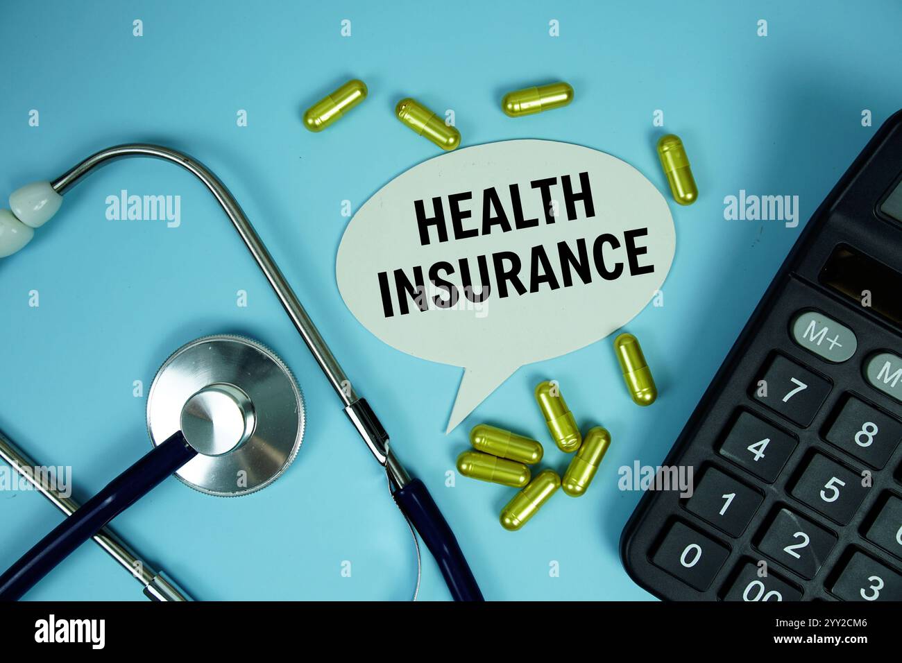 Health Insurance text with calculator, stethoscope and capsule medicine ...