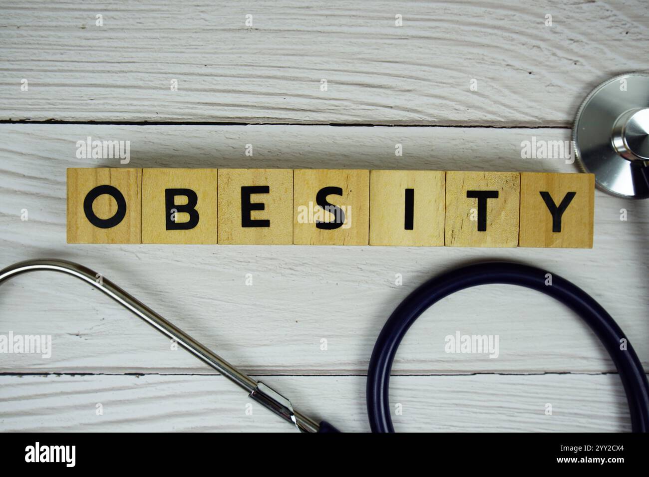 Obesity with wooden blocks alphabet letters and stethoscope on wooden ...
