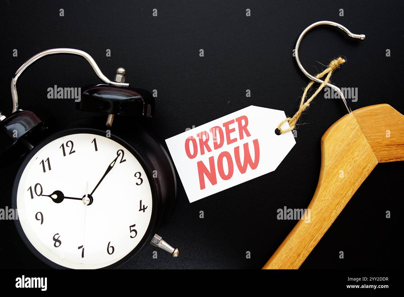 Order Now on price tag with wooden clothes hanger and alarm clock top ...