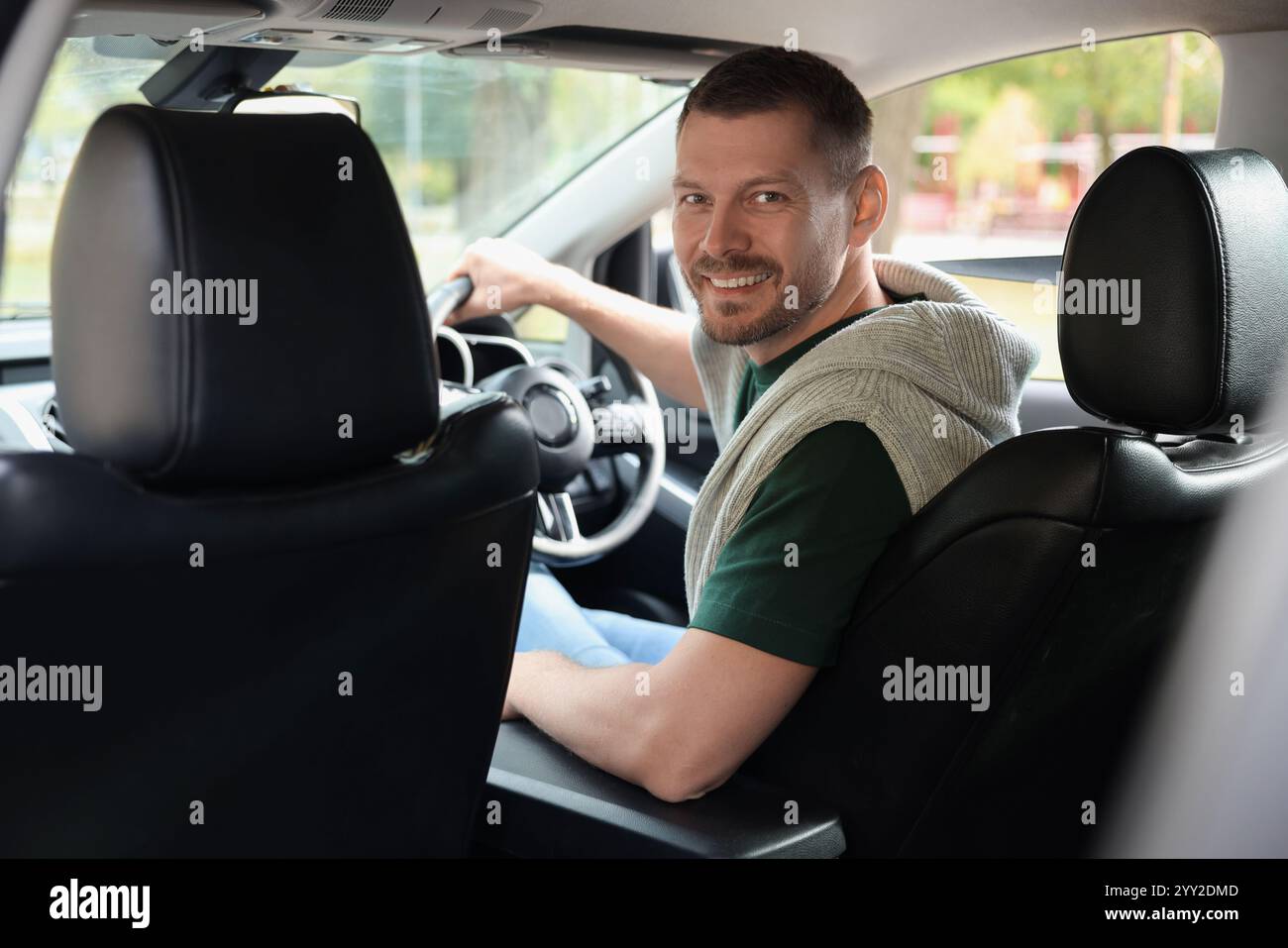 Happy man behind steering wheel of modern car Stock Photo - Alamy