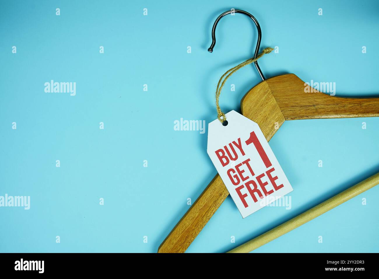 Buy 1 Get 1 Free on price tag with wooden clothes hanger top view on ...