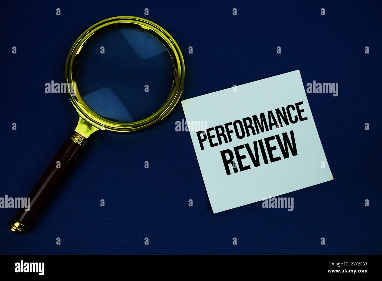 Proformance Review text on speech bluble with magnifying glass top view ...