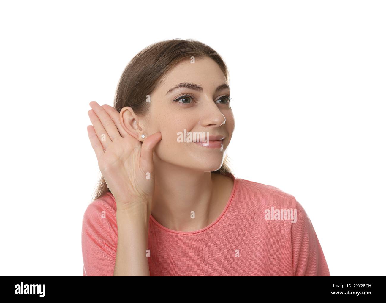 Woman showing hand to ear gesture on white background Stock Photo - Alamy