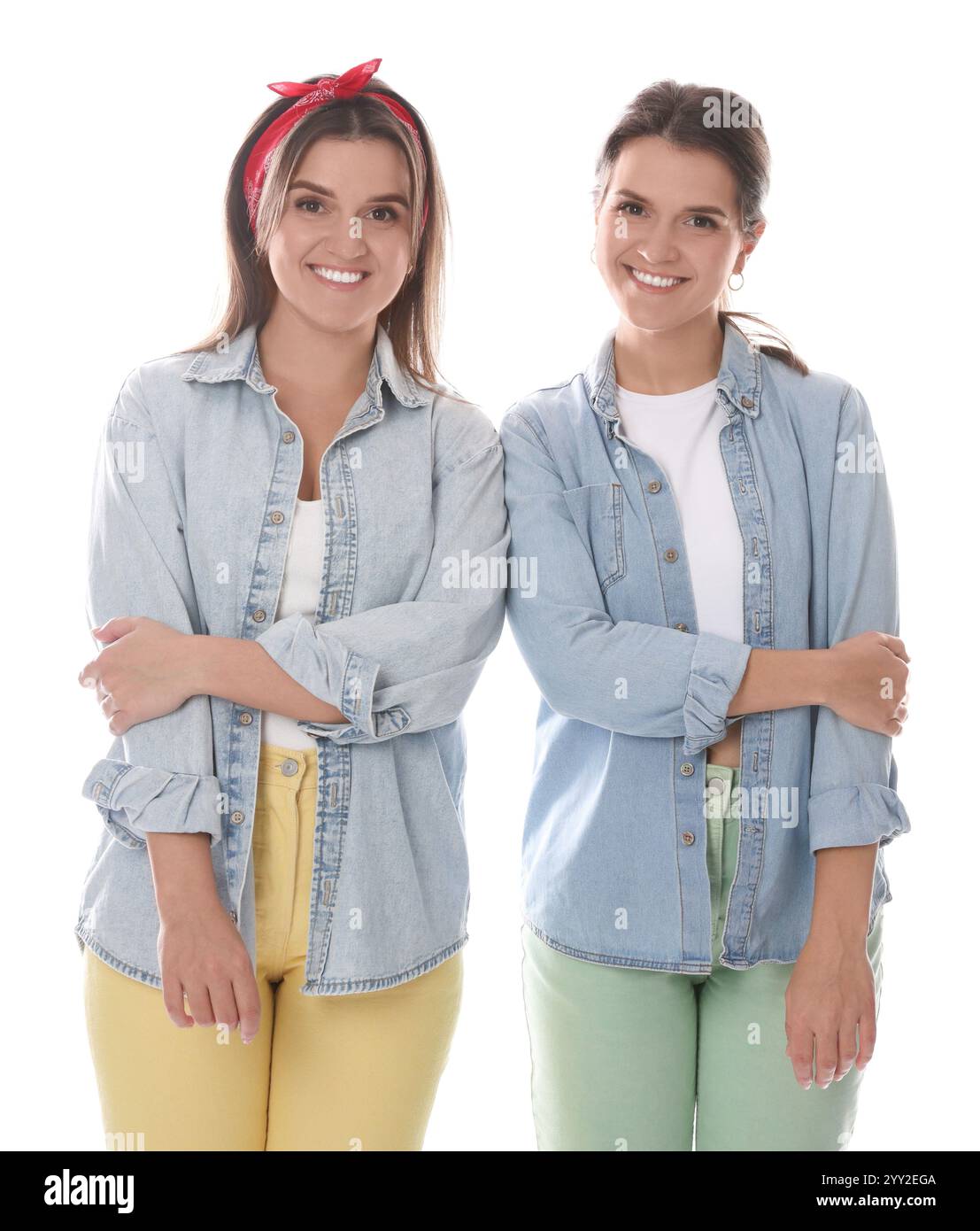 Portrait of beautiful twin sisters on white background Stock Photo - Alamy