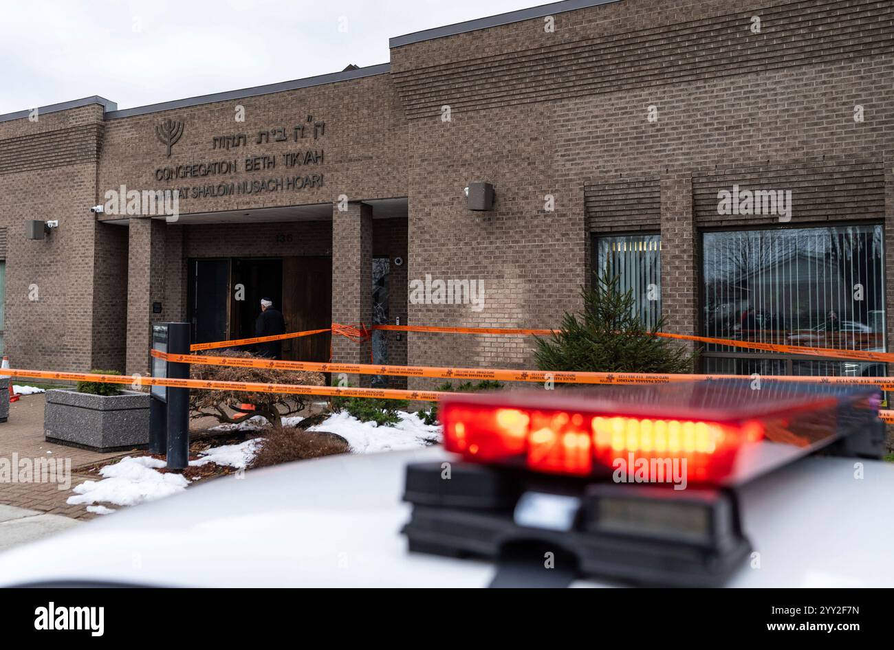 A police car sits outside Congregation Beth Tikvah as police investigate an alleged arson at the ...