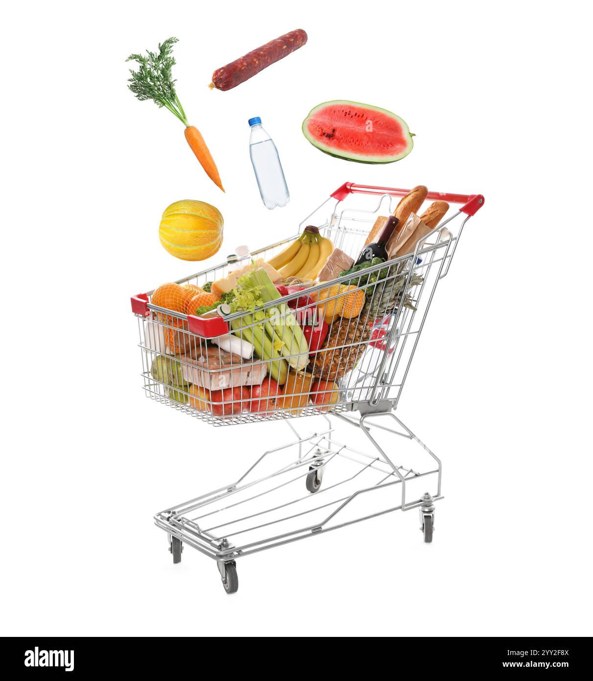 Groceries falling into shopping cart on white background Stock Photo ...