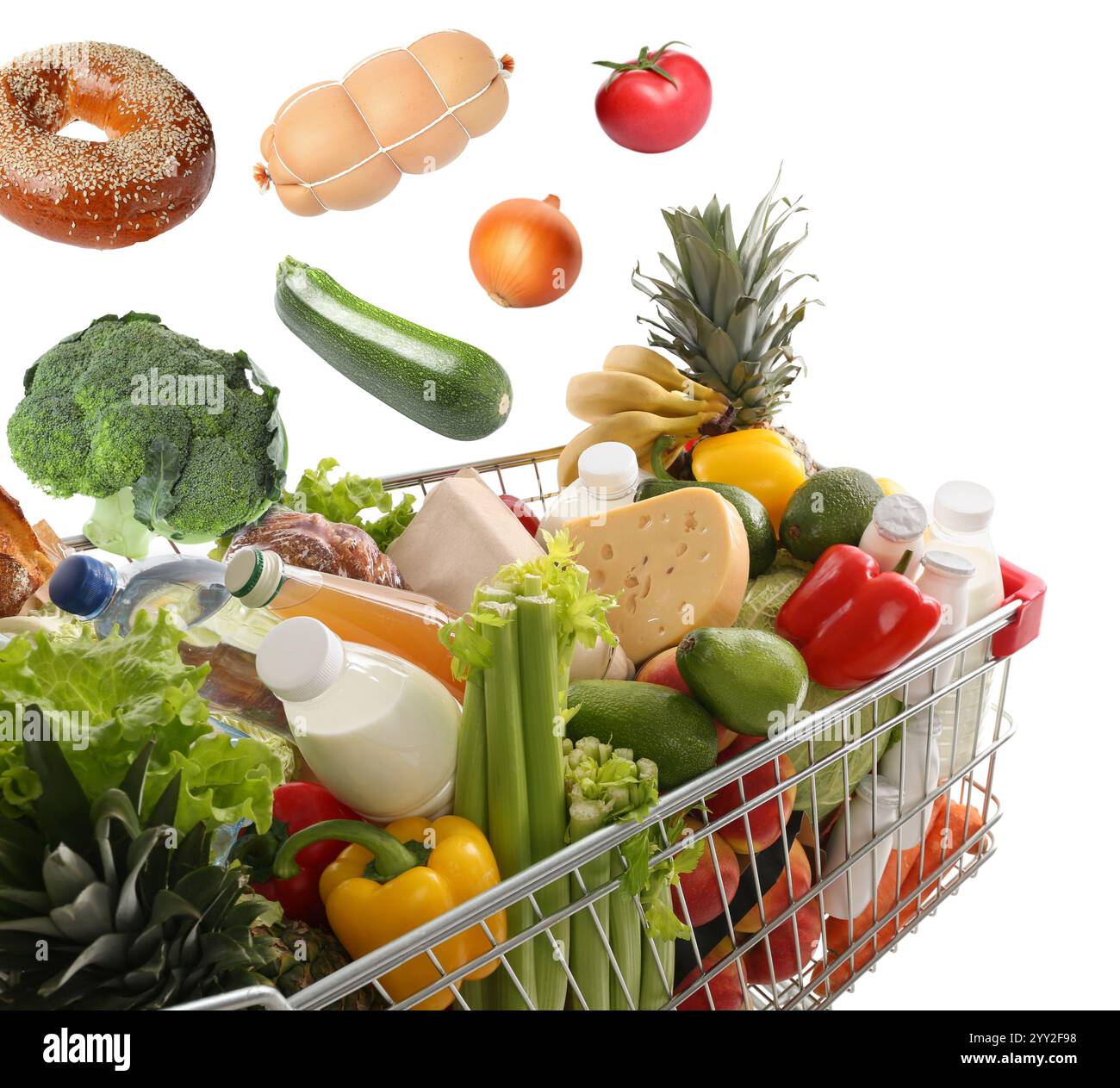 Groceries falling into shopping cart on white background Stock Photo ...