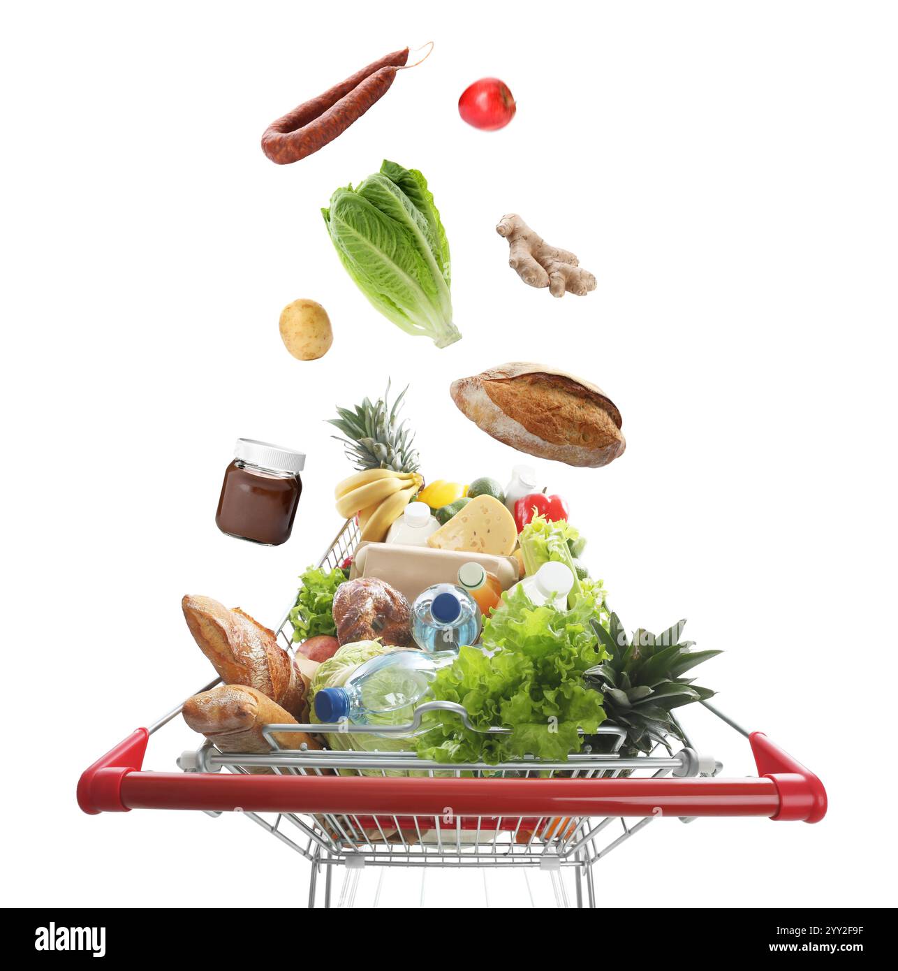 Groceries falling into shopping cart on white background Stock Photo ...