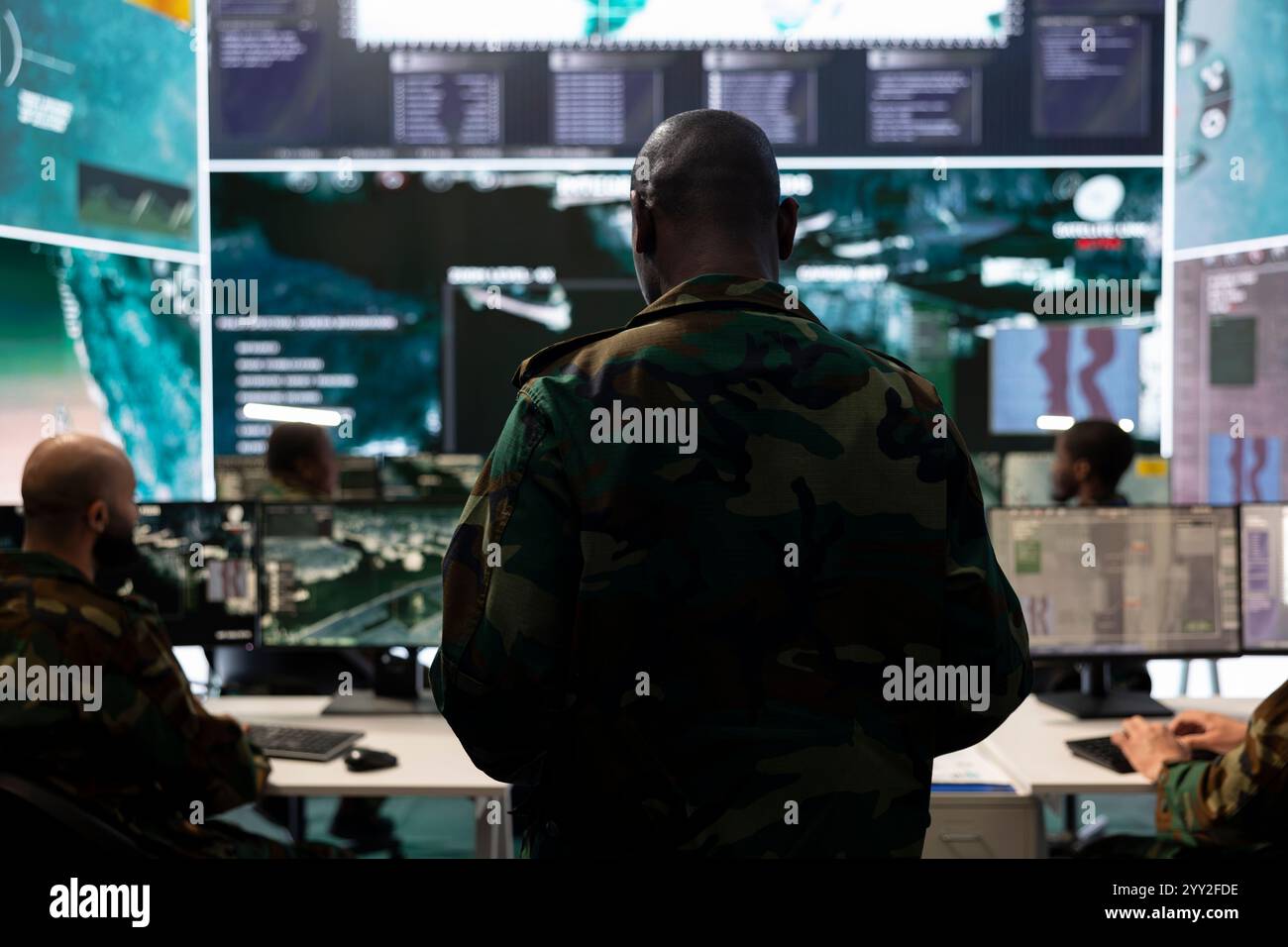 Infantry unit trooper collecting intelligence for a field operation, working with high tech ...