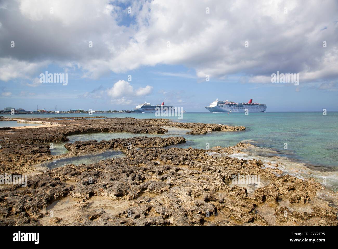 The view of eroded rocky Grand Cayman island shore and cruise ships ...