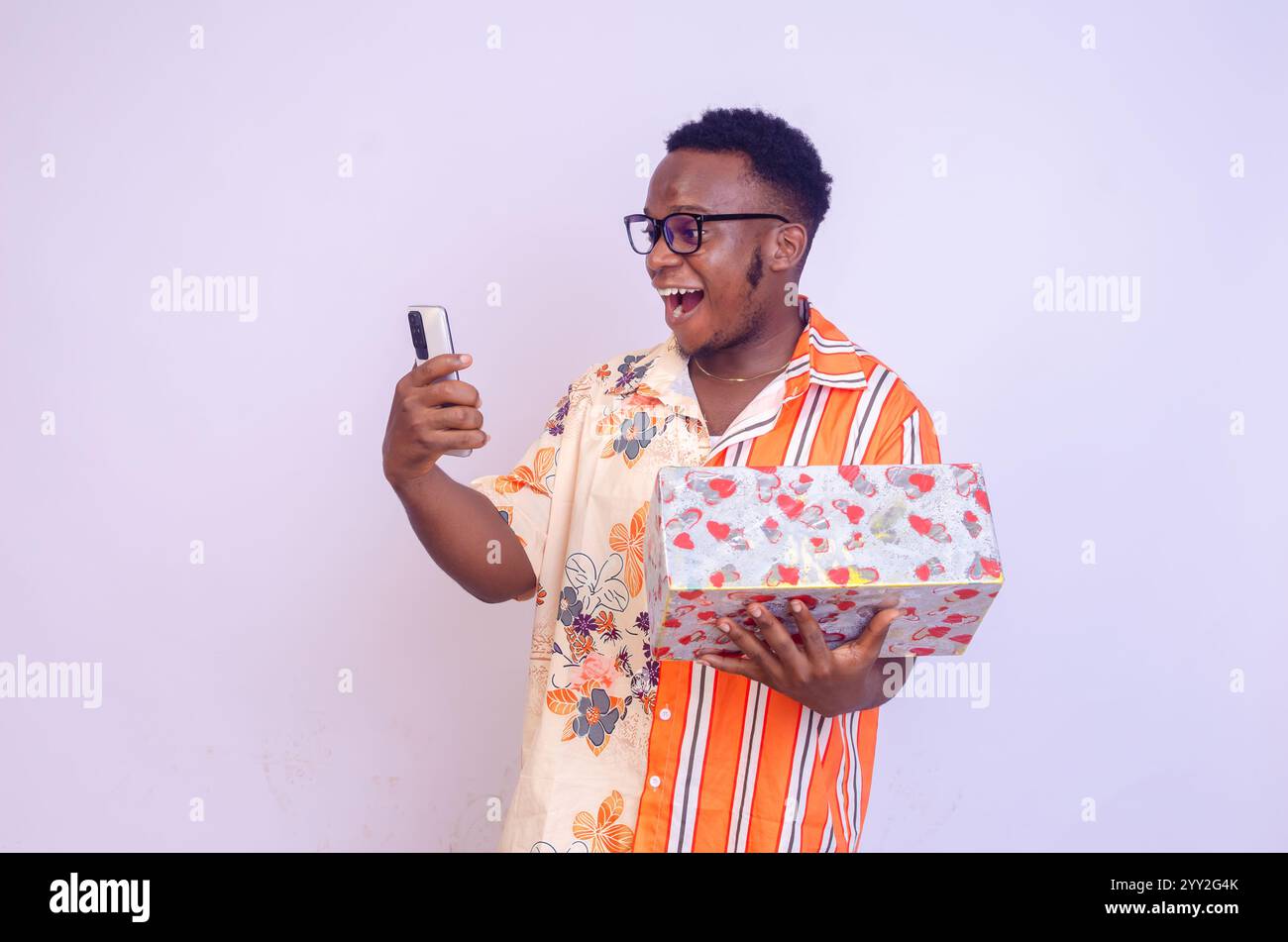 Photo of a handsome nice funny man make order hold gift box Stock Photo ...