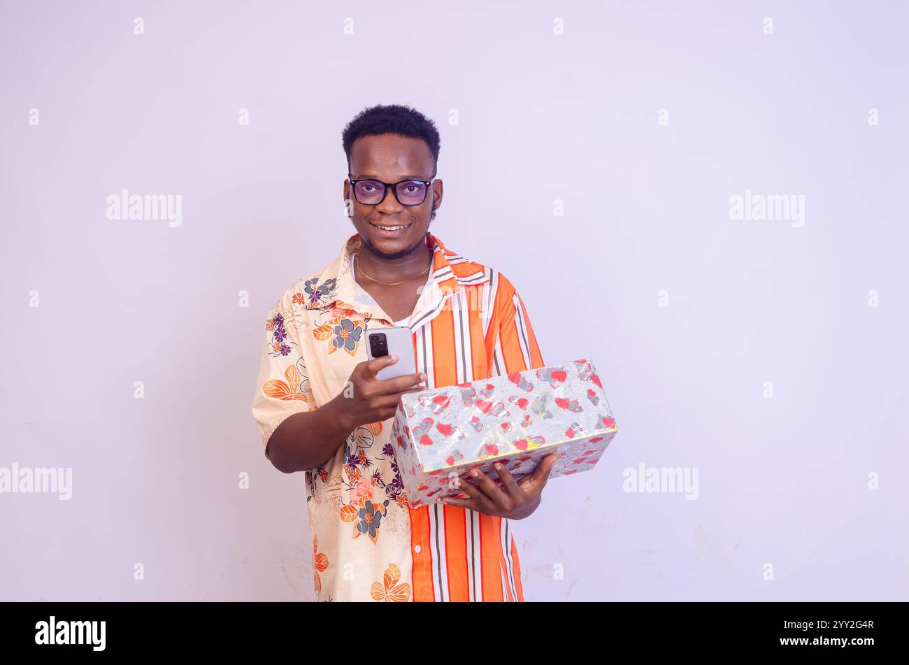 Photo of a handsome nice funny man make order hold gift box Stock Photo ...