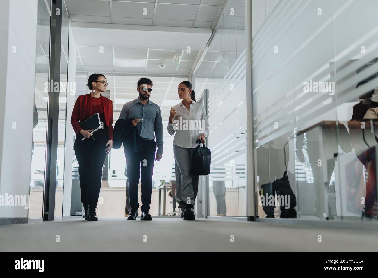 Group of business people confidently walking through a contemporary ...