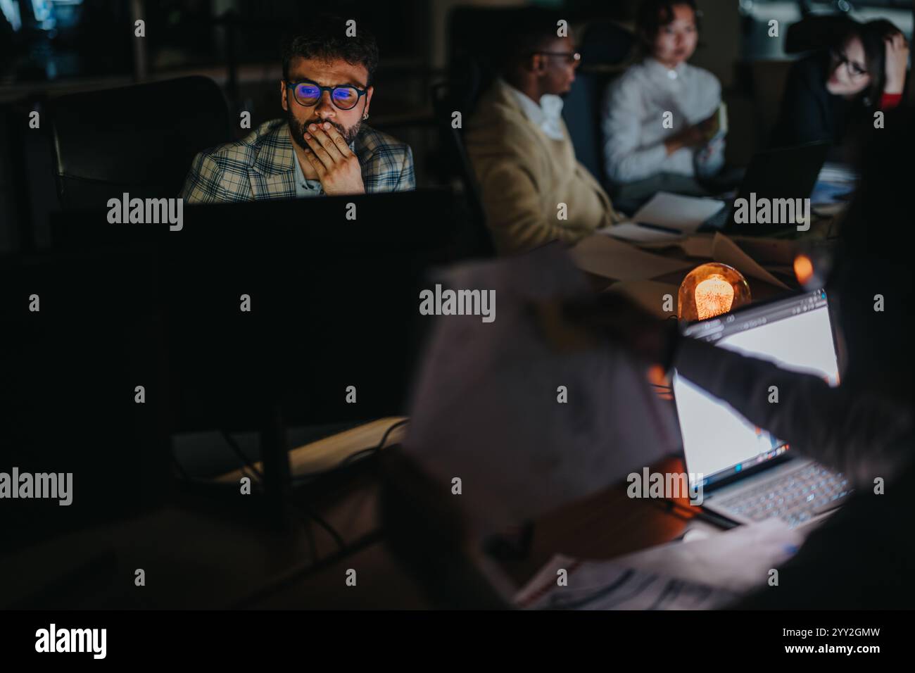 Business team working late in the office with focused expressions Stock ...