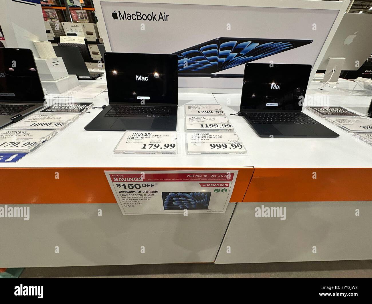 A discount sign hangs from the counter below MacBook Air laptop ...