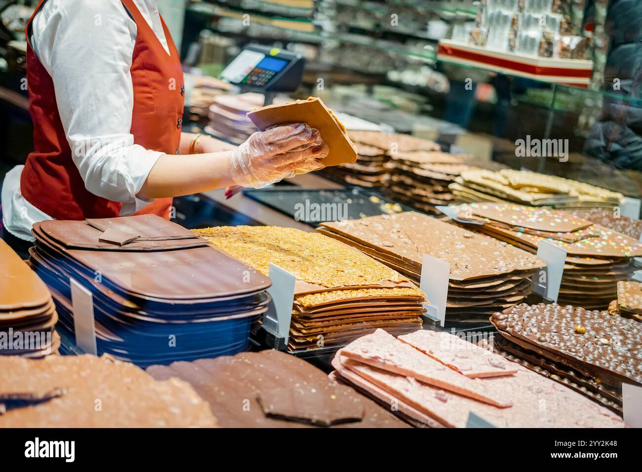 Chocolate vendor with large slabs of artisan chocolate at market stall ...