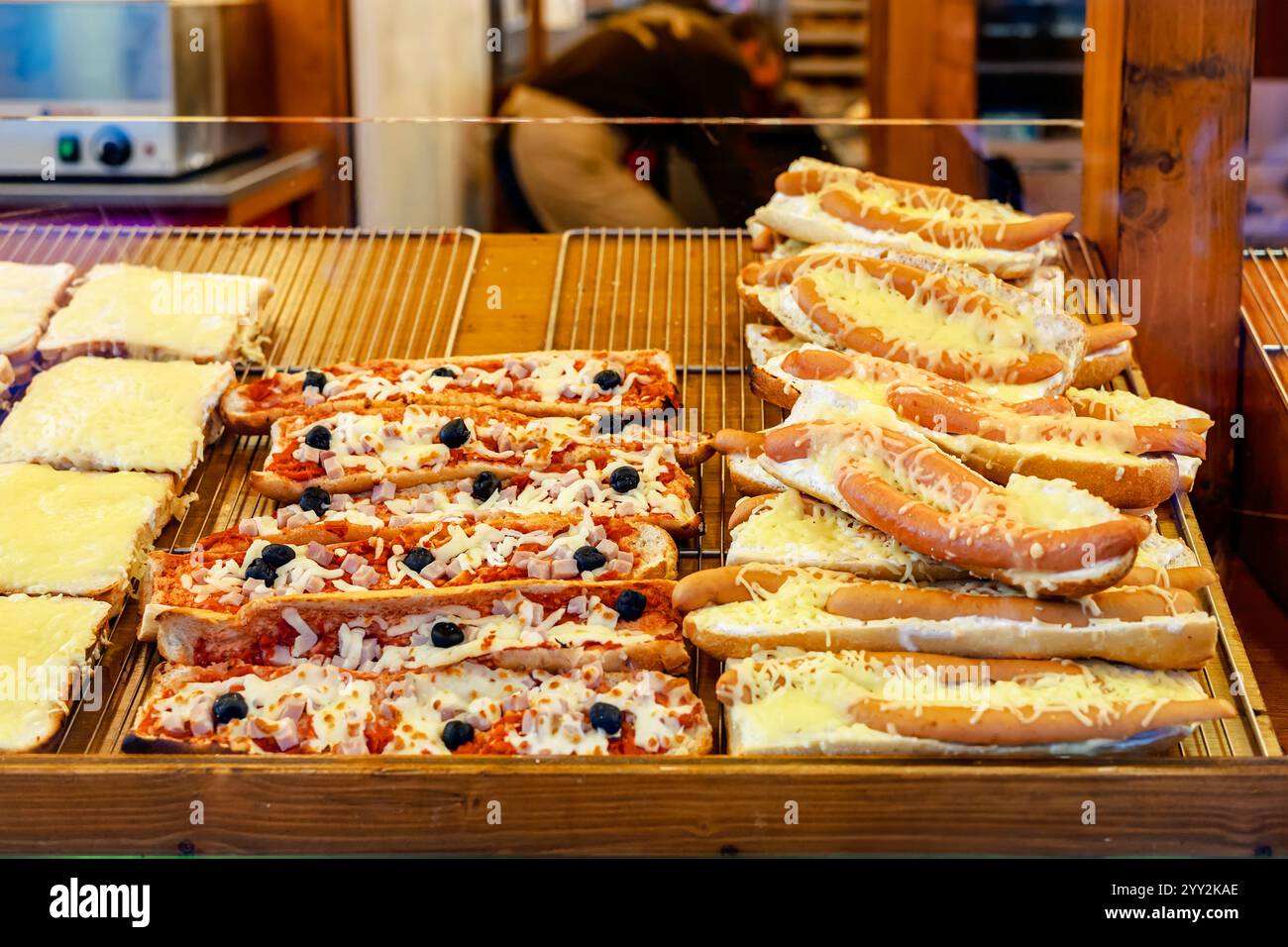 Cheesy bread, pizza slices topped with olives and sausage. Concept of ...