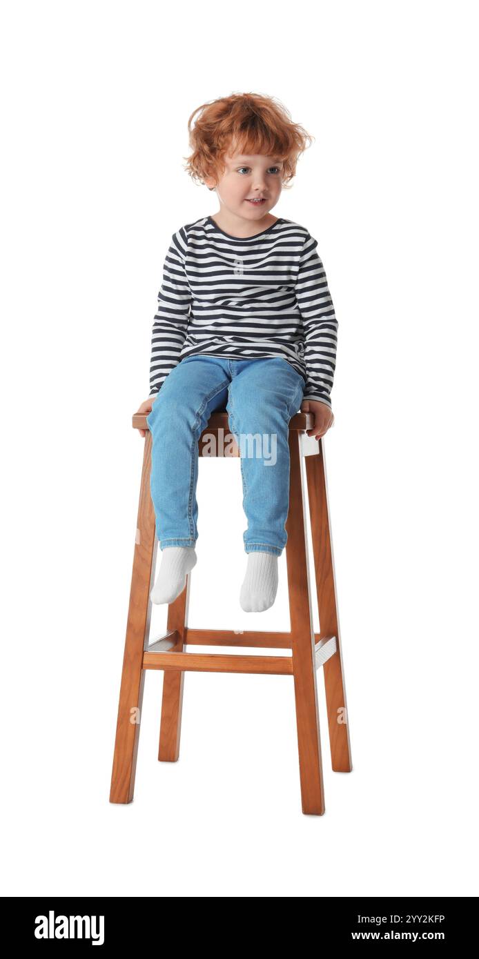 Little boy sitting on stool against white background Stock Photo - Alamy