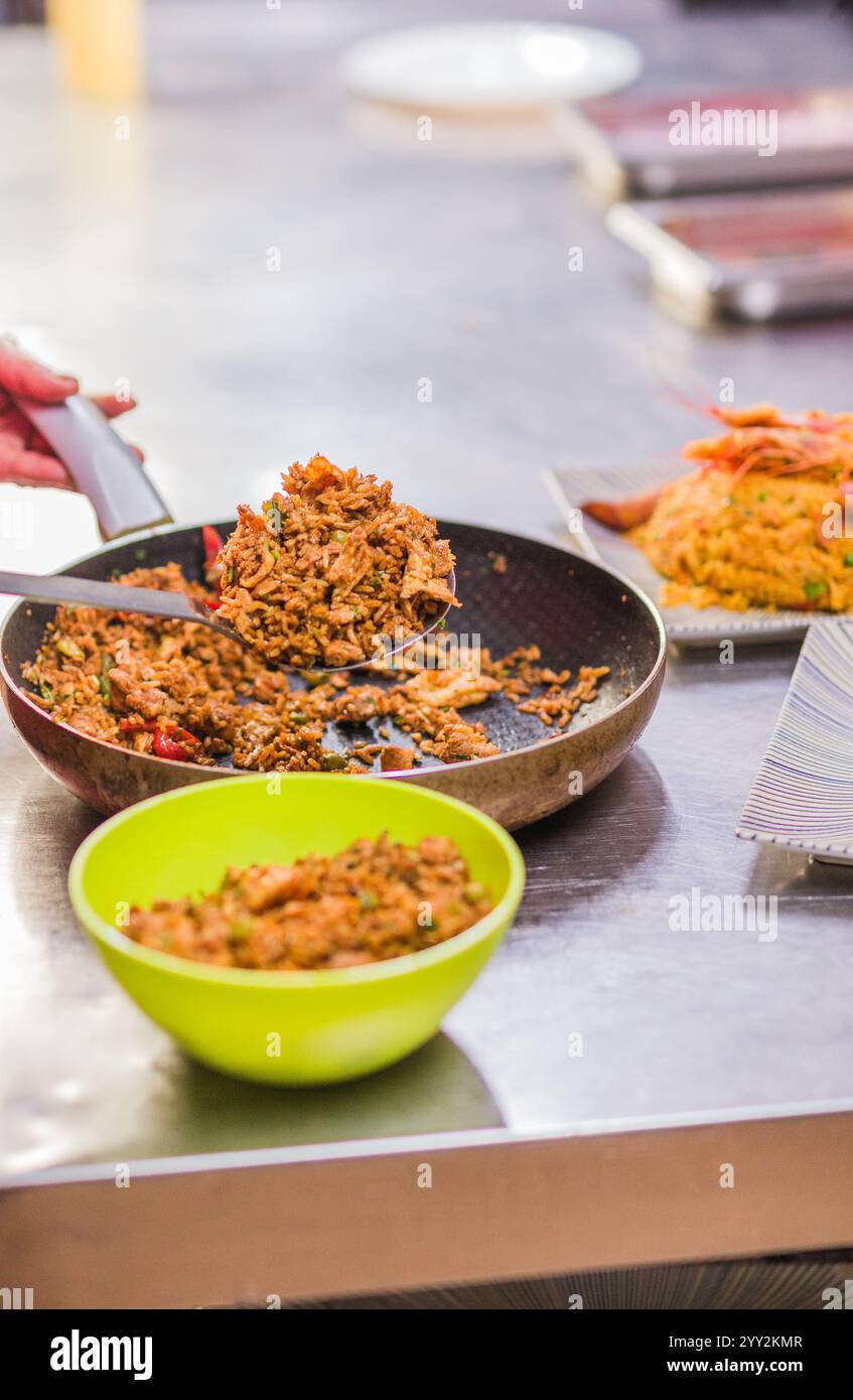 Chef preparing Chaulafan con marisco traditional ecuadorian dish in ...