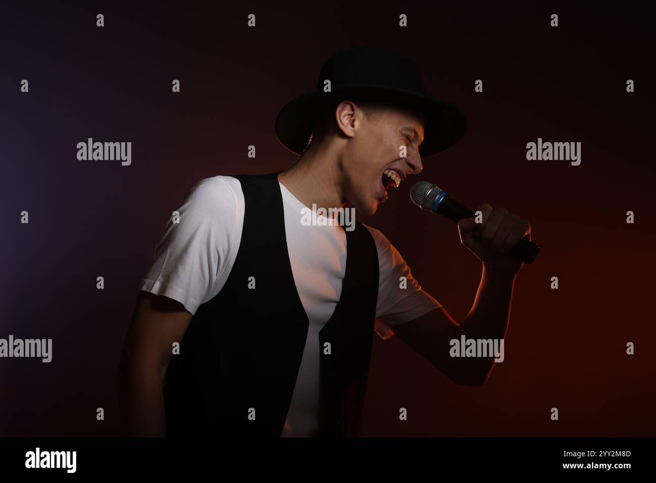Young man singing talent show hi-res stock photography and images - Alamy