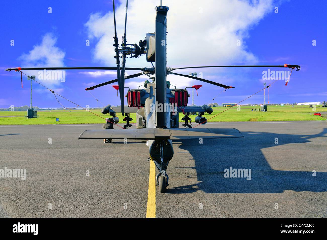 Apache attack helicopter at a UK airbase against deep blue sky with ...