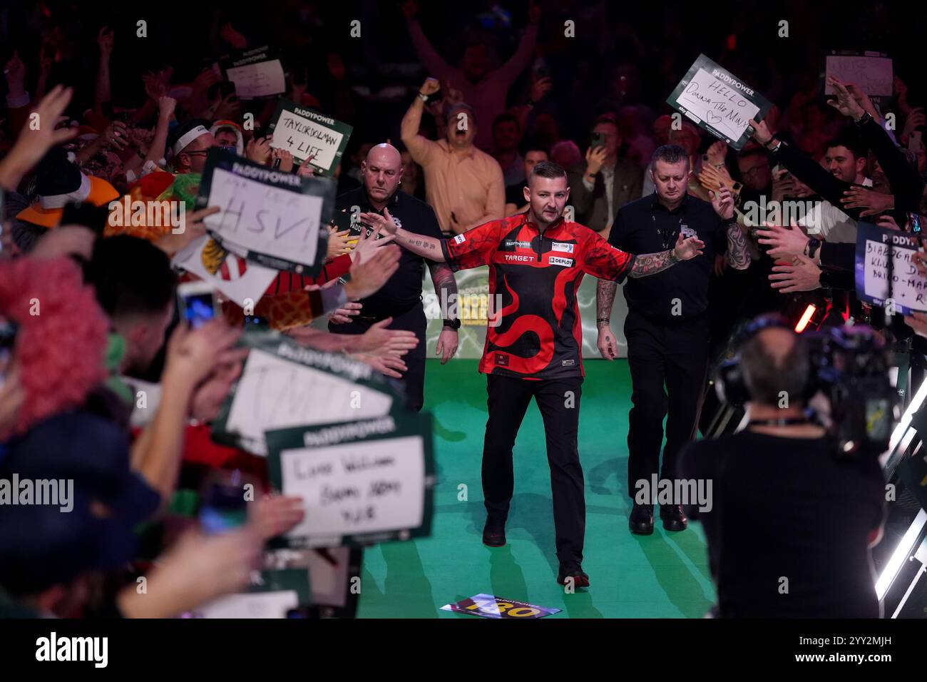 Nathan Aspinall walks out ahead of his second round match against ...