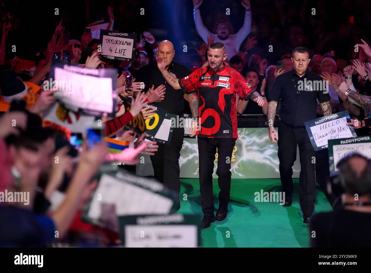 Nathan Aspinall walks out ahead of his second round match against ...
