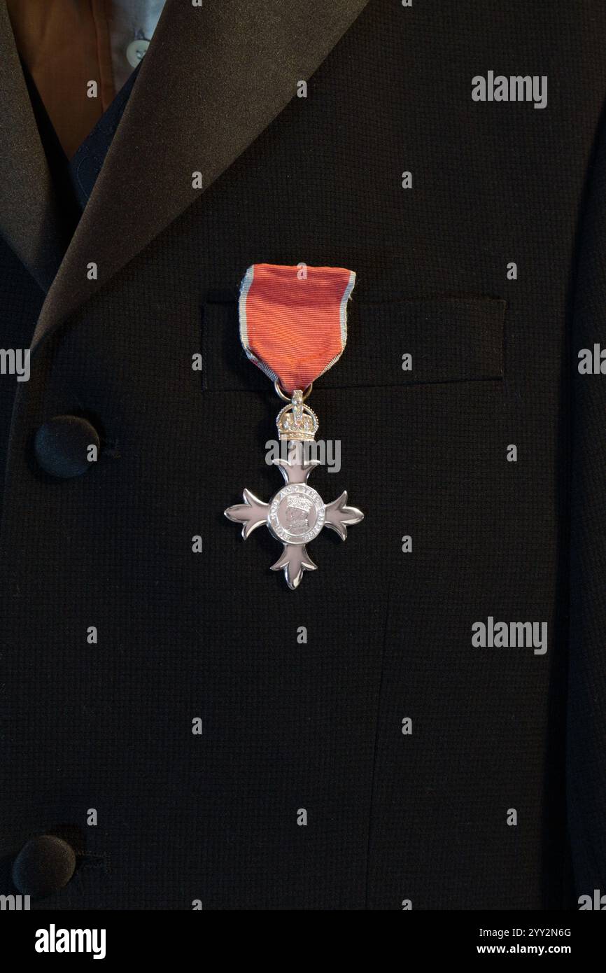 British MBE medal worn on black tuxedo jacket, Member of the British ...