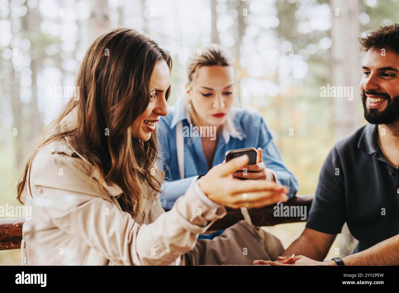 Group of friends enjoying a conversation in a forest setting Stock ...