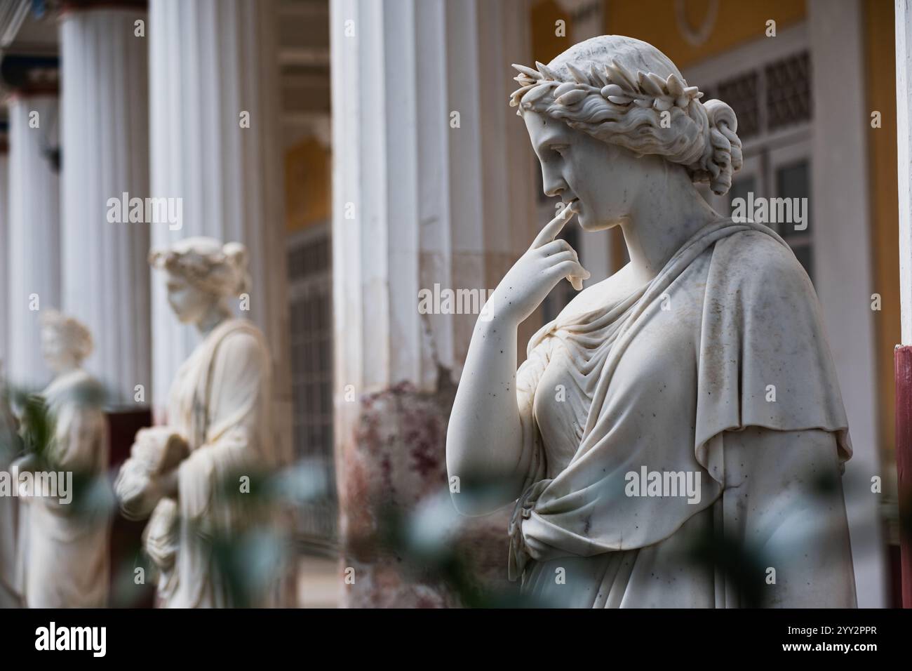 Antique statues of Women in Wreaths. The white stone statues stand in a ...