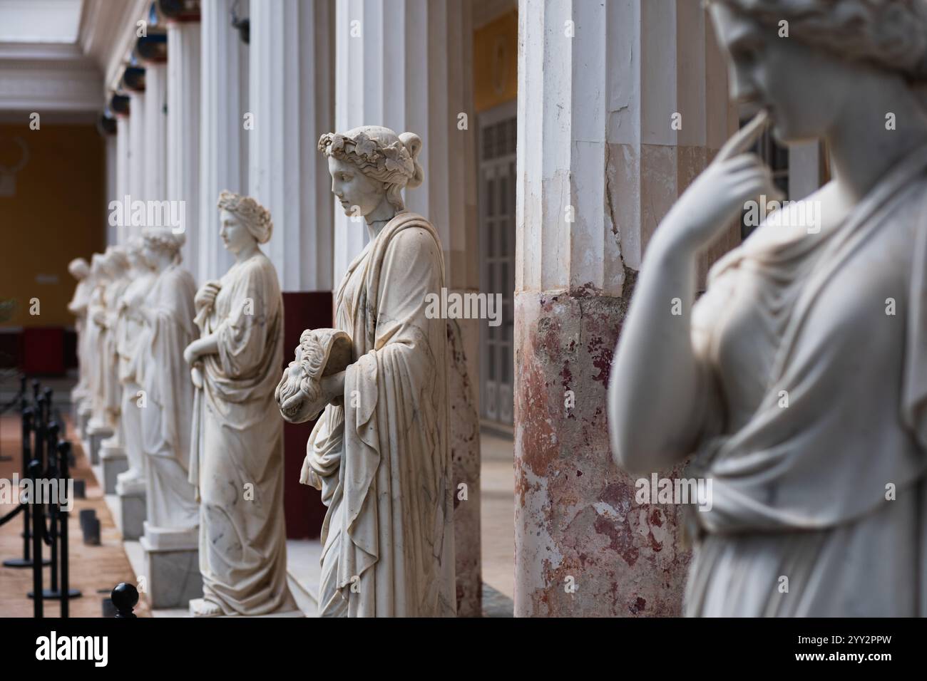 Antique statues of Women in Wreaths. The white stone statues stand in a ...
