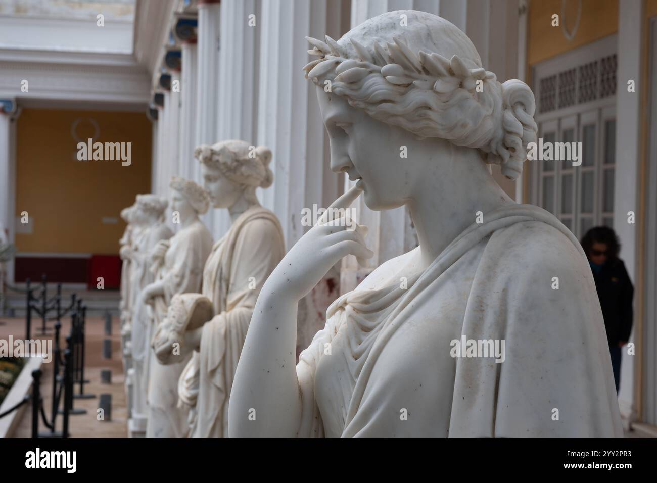 Antique statues of Women in Wreaths. The white stone statues stand in a ...