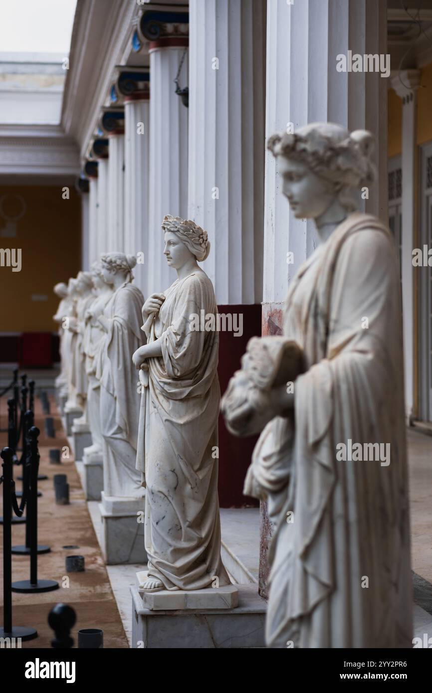 Antique statues of Women in Wreaths. The white stone statues stand in a ...