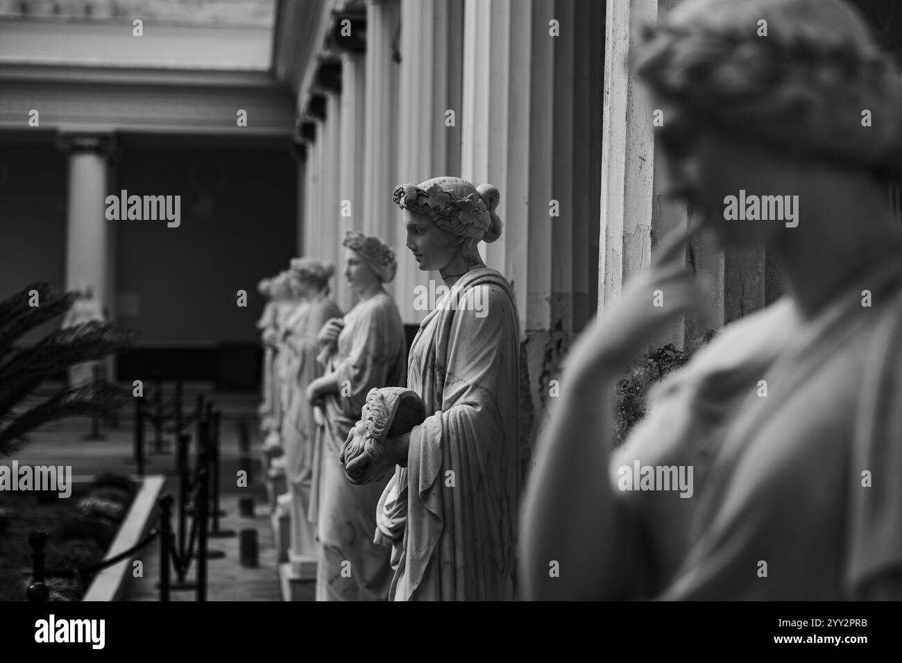 Antique statues of Women in Wreaths. The white stone statues stand in a ...