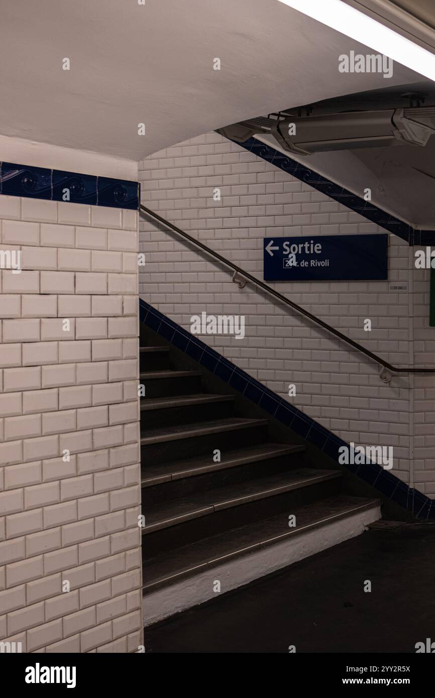 Exit from the Paris metro. Sign: Exit and street name. Steps and a ...