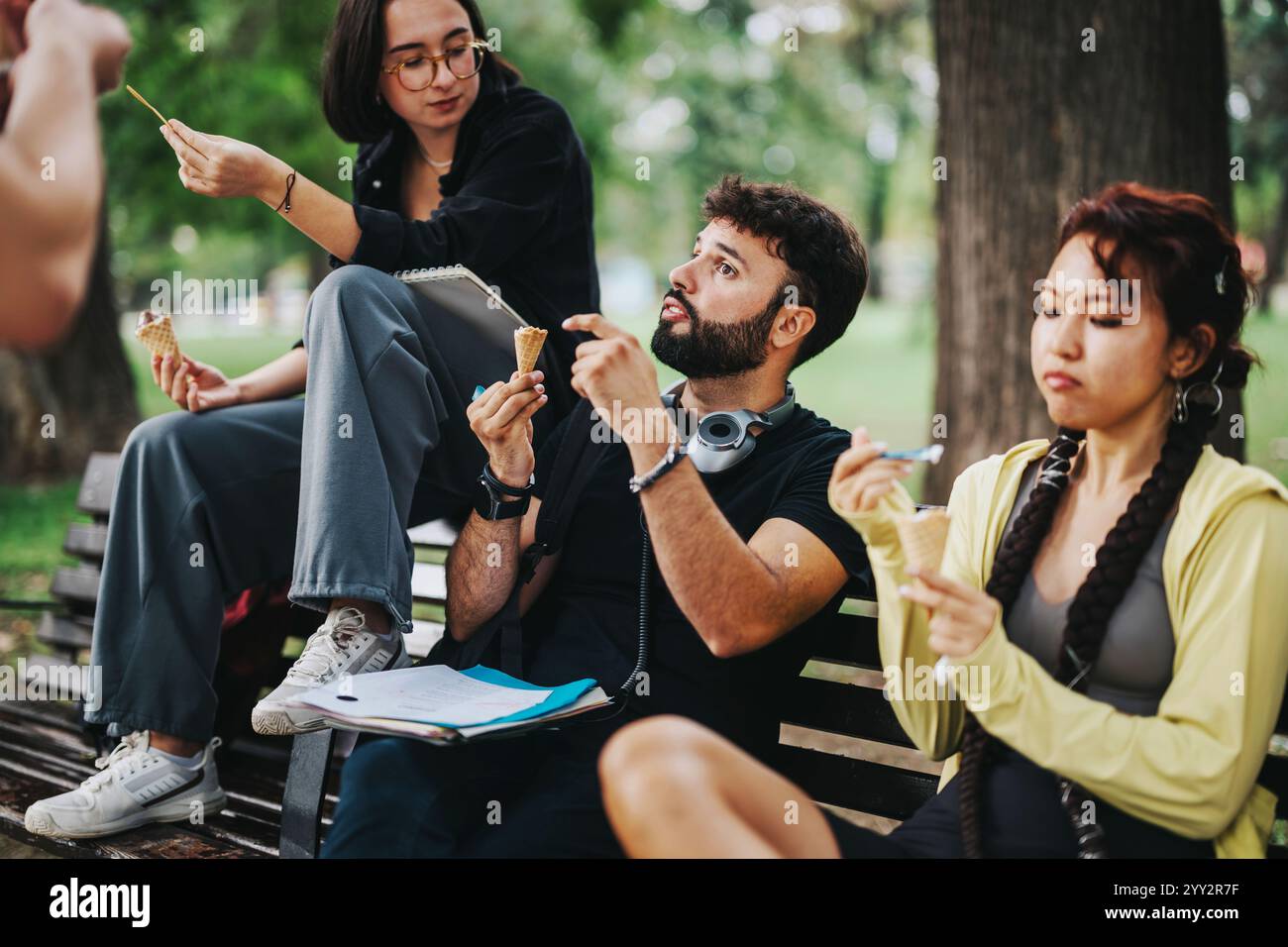 Students and professor enjoying ice cream break outdoors after class ...