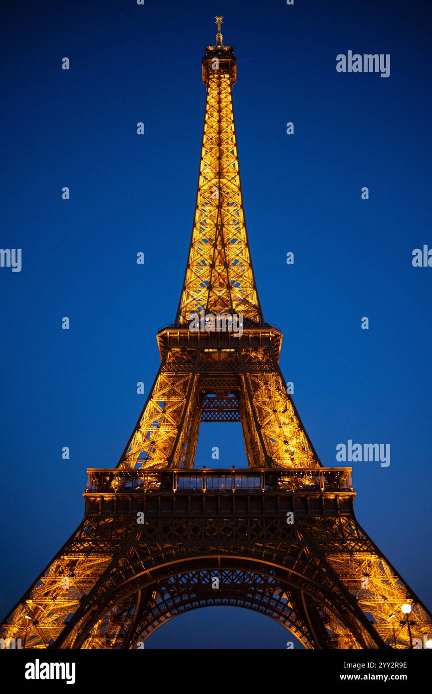 Eiffel Tower at night. Beautiful glow of the tower against the black night sky. The main ...