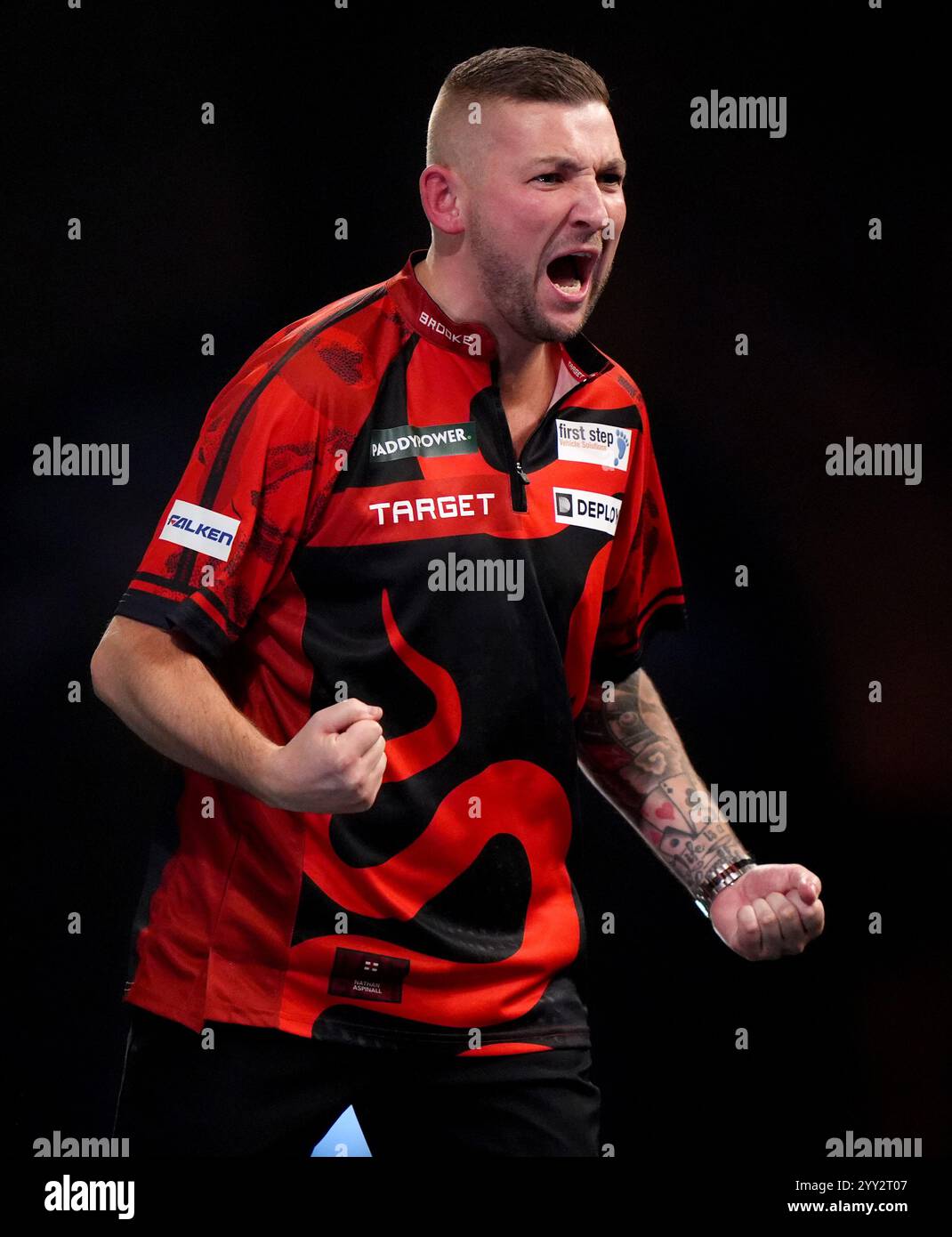 Nathan Aspinall celebrates during his second round match against ...