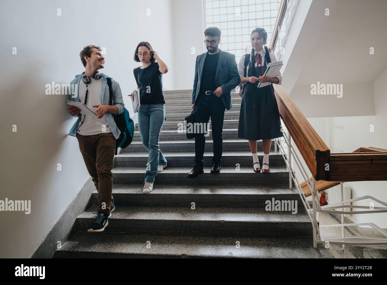 Group of students and professor walking down school stairs Stock Photo ...