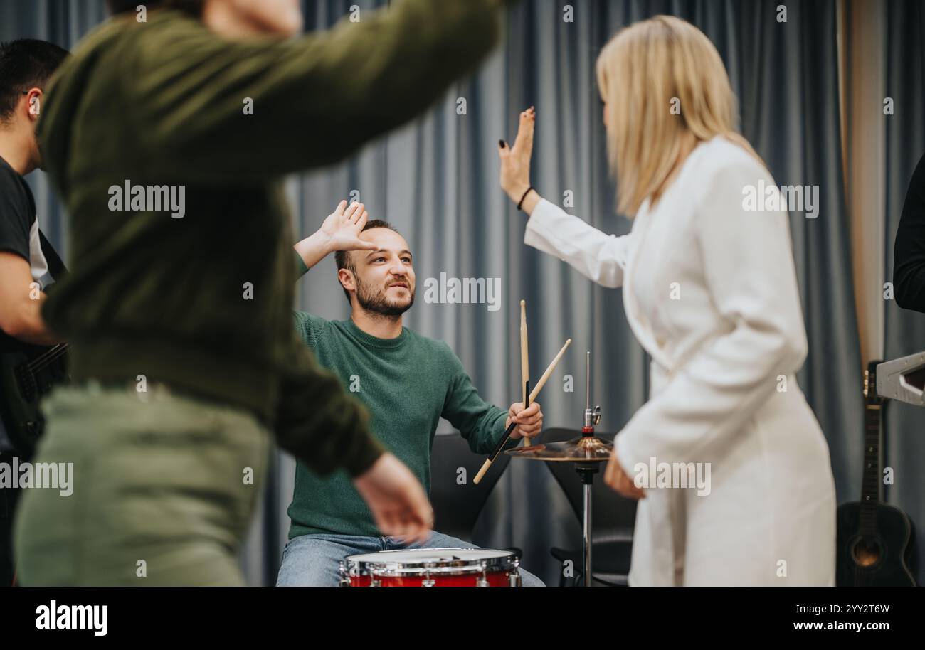 Group of musicians enthusiastically rehearsing in a music studio ...