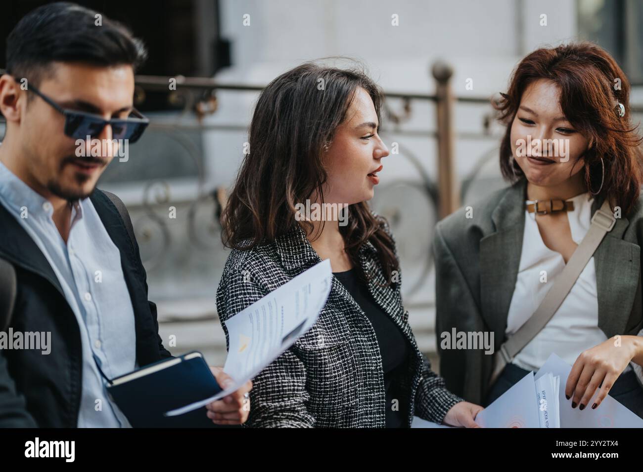 Business people engaged in a dynamic outdoor meeting Stock Photo - Alamy