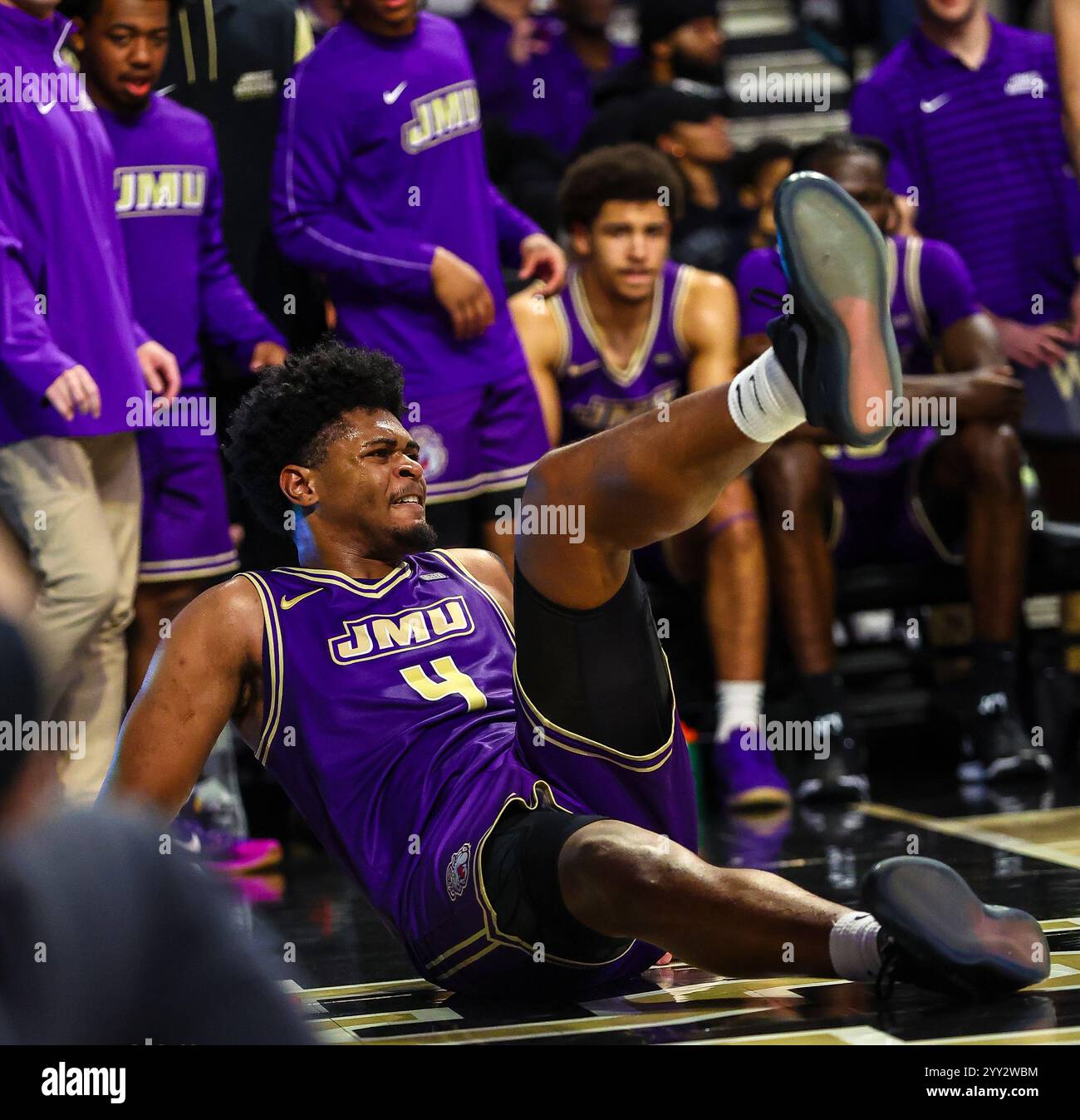 December 17, 2024: James Madison center Elijah Hutchins-Everett (4) goes down with cramp. NCAA ...