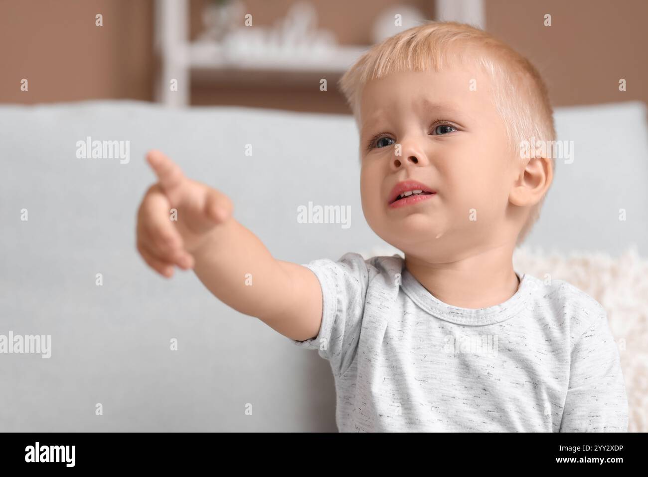 Cute baby boy crying at home, closeup Stock Photo - Alamy