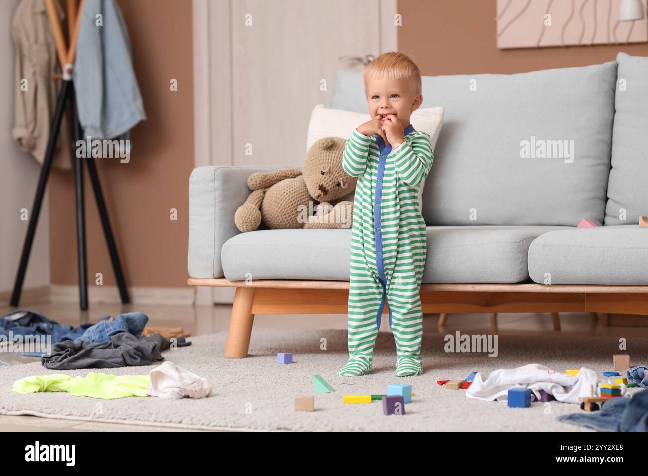 Naughty baby boy in messy room Stock Photo - Alamy
