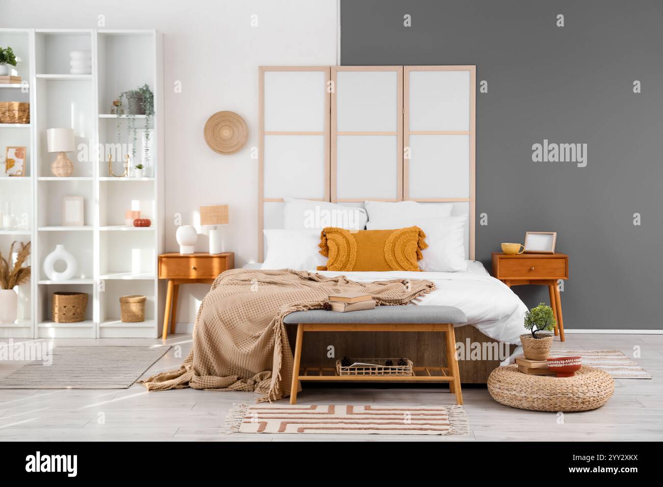 Interior of modern bedroom with big bed, folding screen and shelving ...