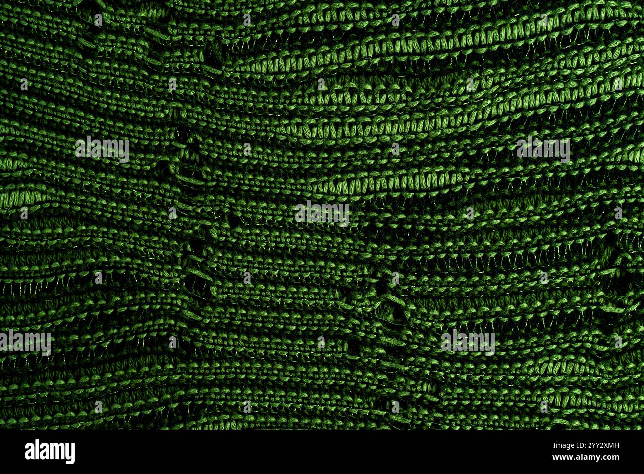 A close-up of green knitted fabric texture, detailed pattern, and ...