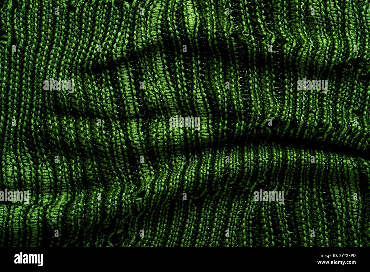 A close-up of green knitted fabric texture, detailed pattern, and ...
