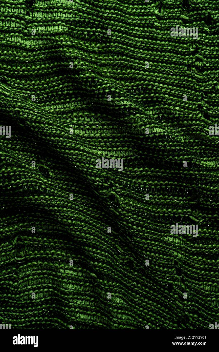 A close-up of green knitted fabric texture, detailed pattern, and ...