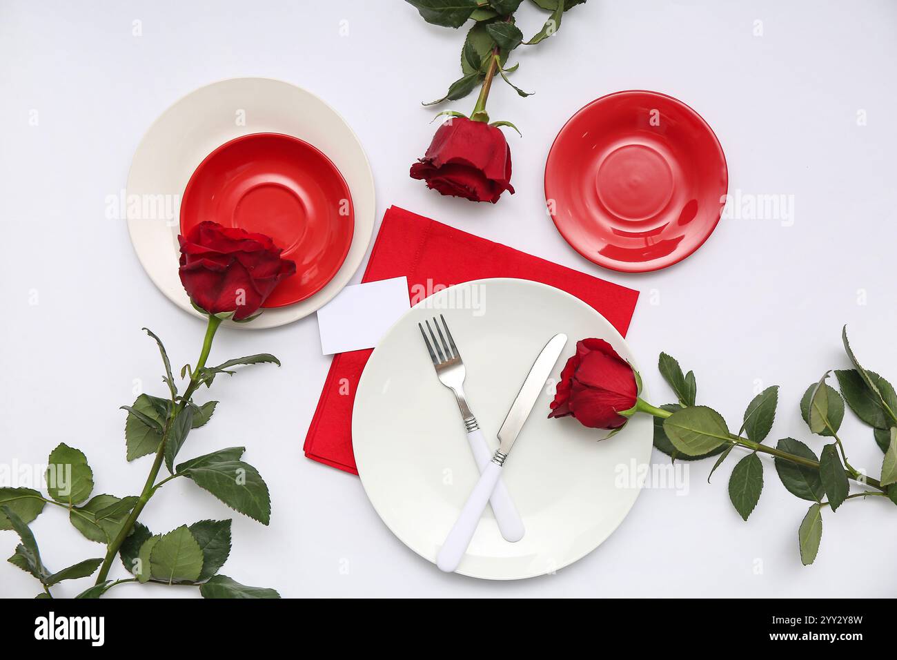 Stylish table setting with beautiful red rose flowers on white ...