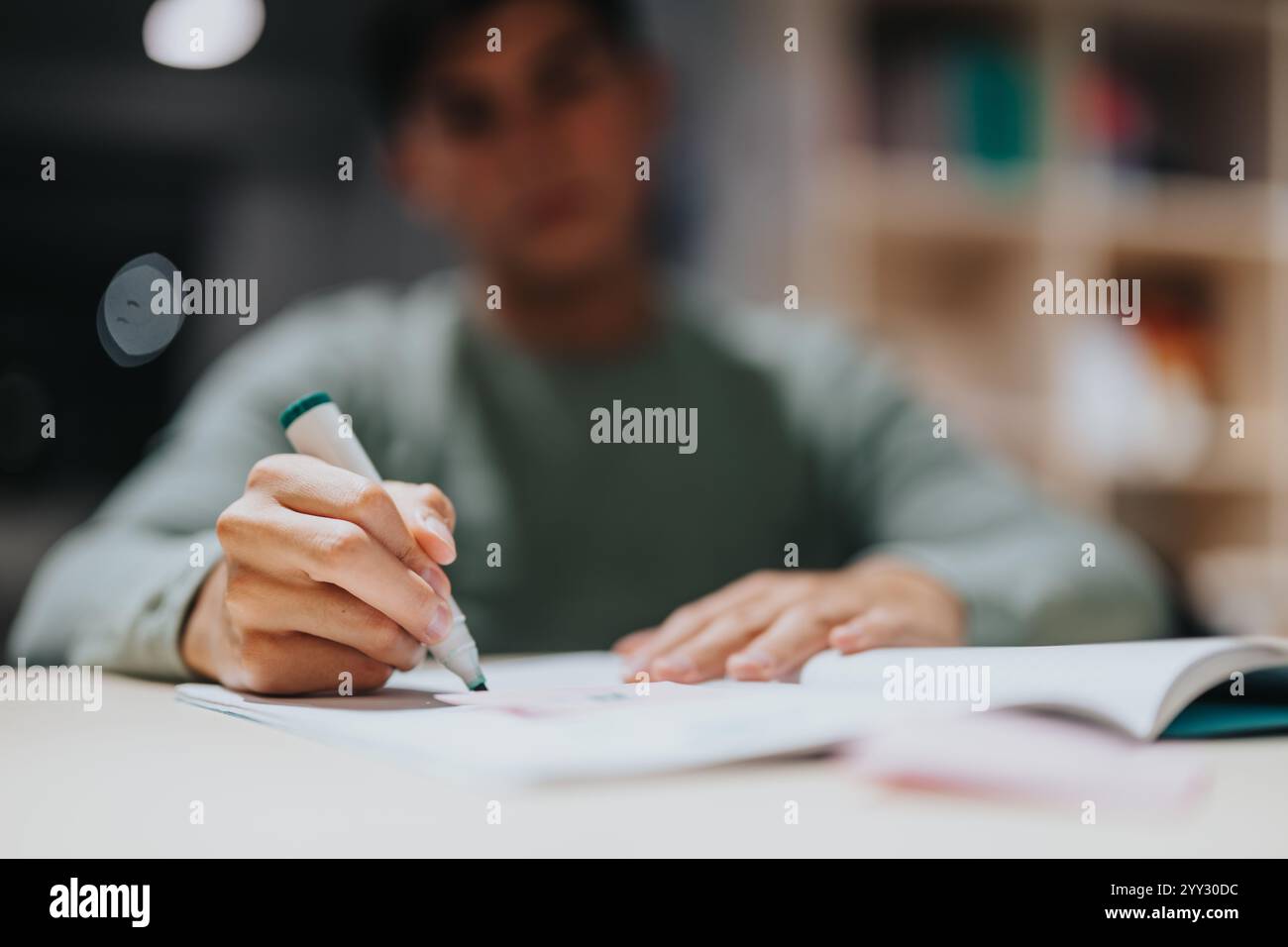 Focused high school student taking notes in classroom setting Stock ...